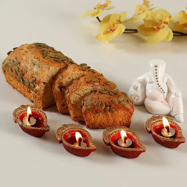 Buy/Send Cinnamon Pumpkin Seed Dry Cake & White Ganesha Online- FNP